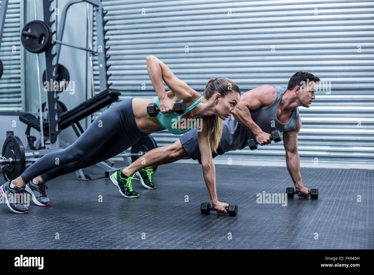 Muscular couple doing plank exercise together Stock Photo - Alamy