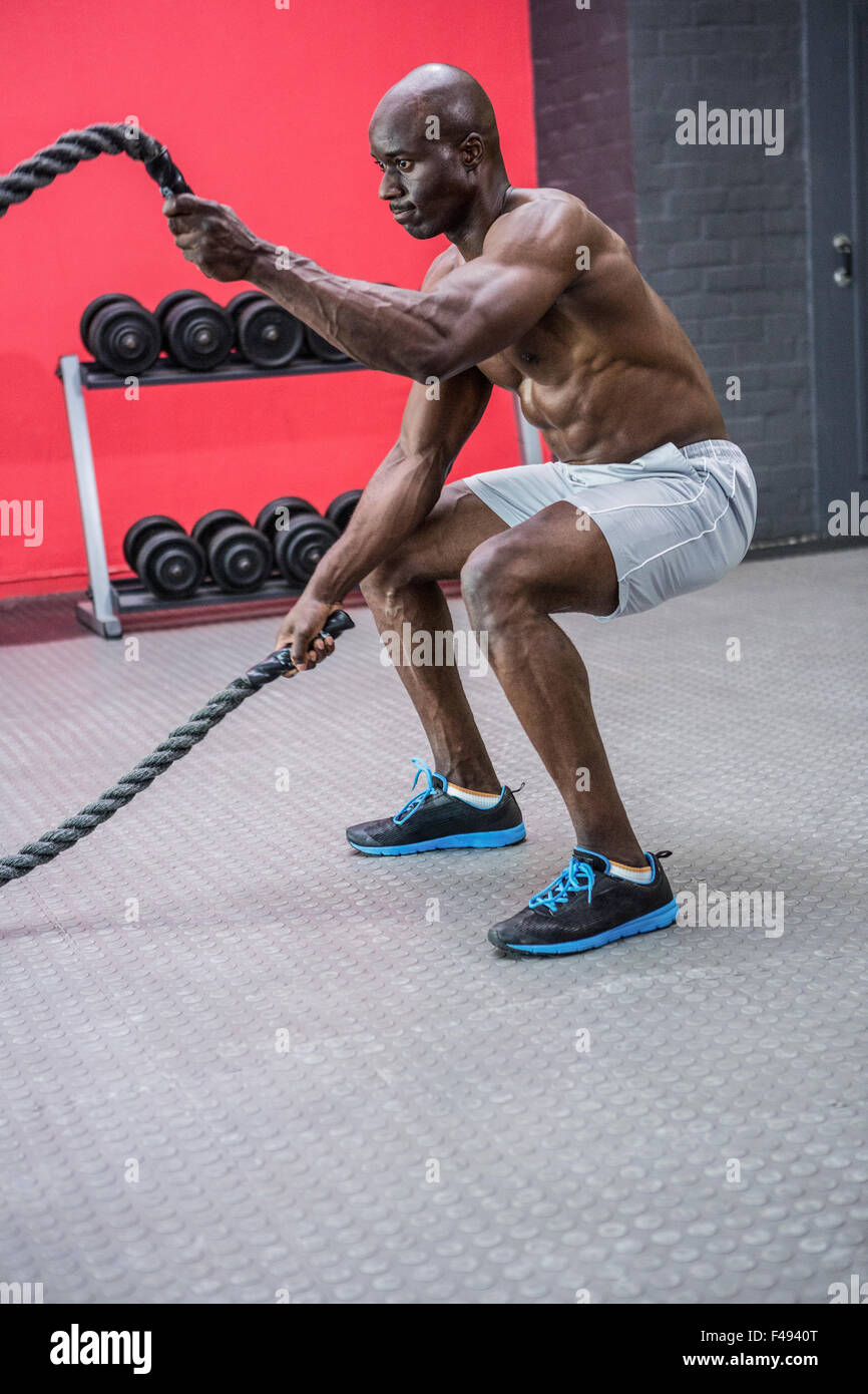 Young Bodybuilder working with ropes Stock Photo - Alamy