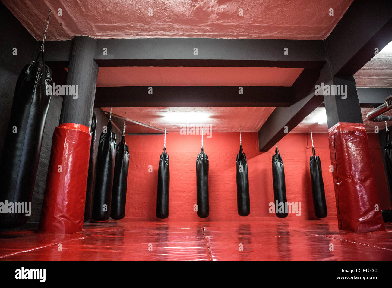 Red boxing area with punching bags Stock Photo - Alamy