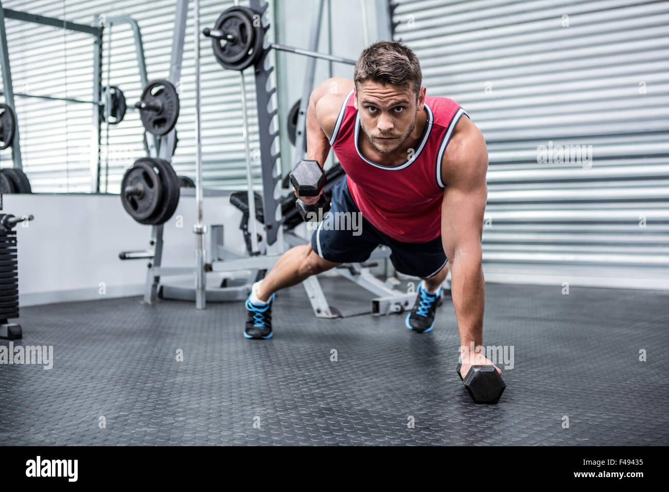 Portrait of muscular man using dumbbells Stock Photo - Alamy
