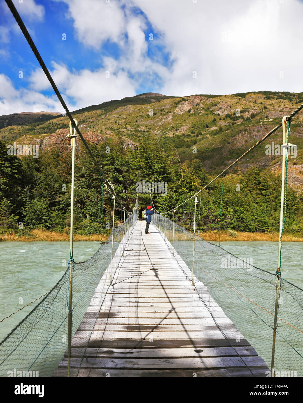 Suspension bridge across mountain river Stock Photo - Alamy