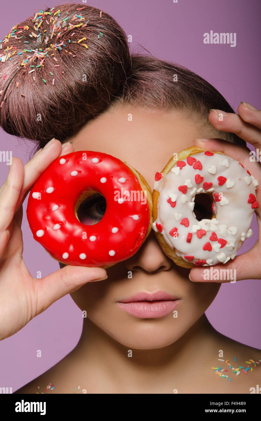 Young woman two donuts eyes hi-res stock photography and images - Alamy