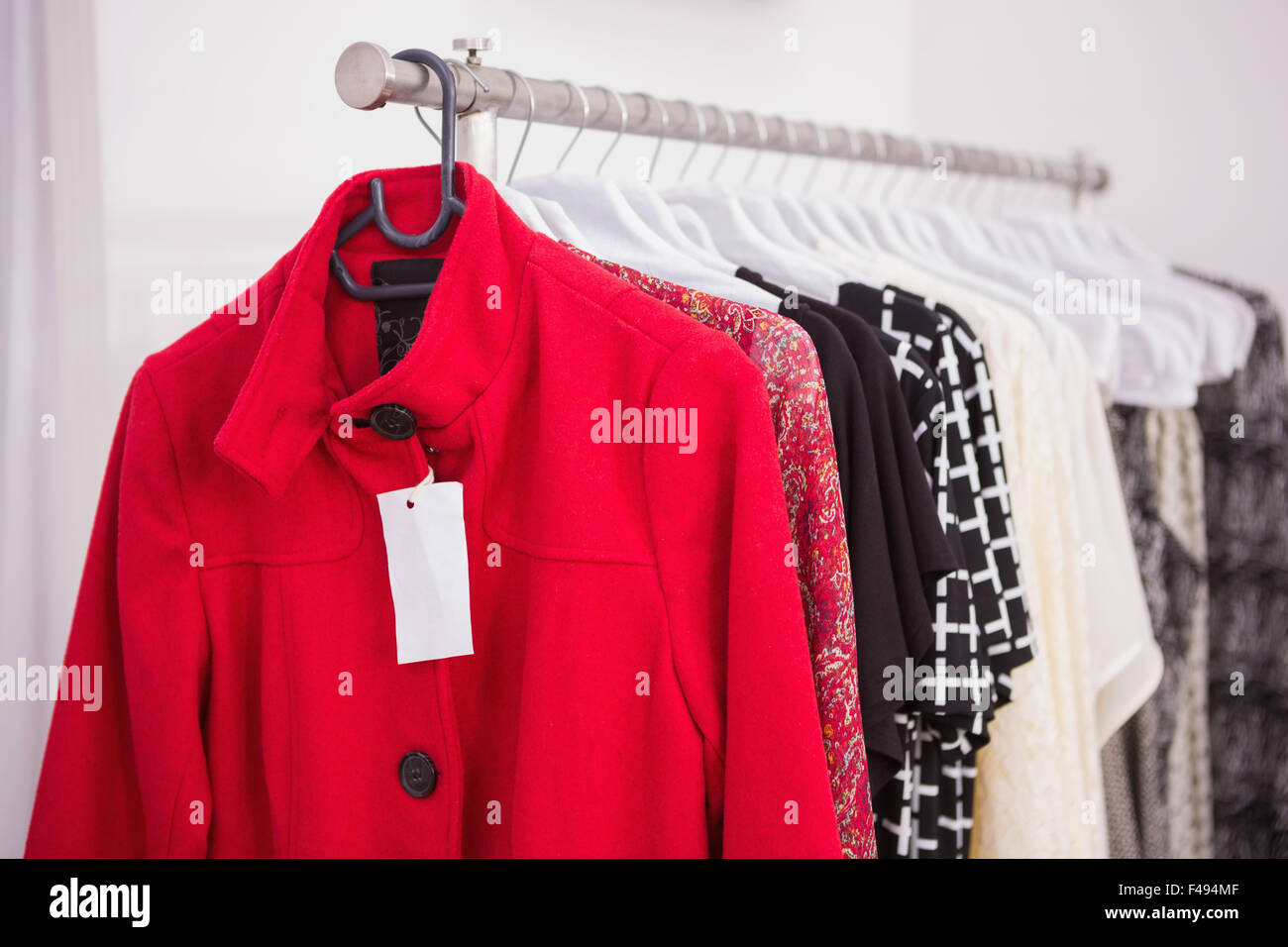Hanging red coat Stock Photo - Alamy