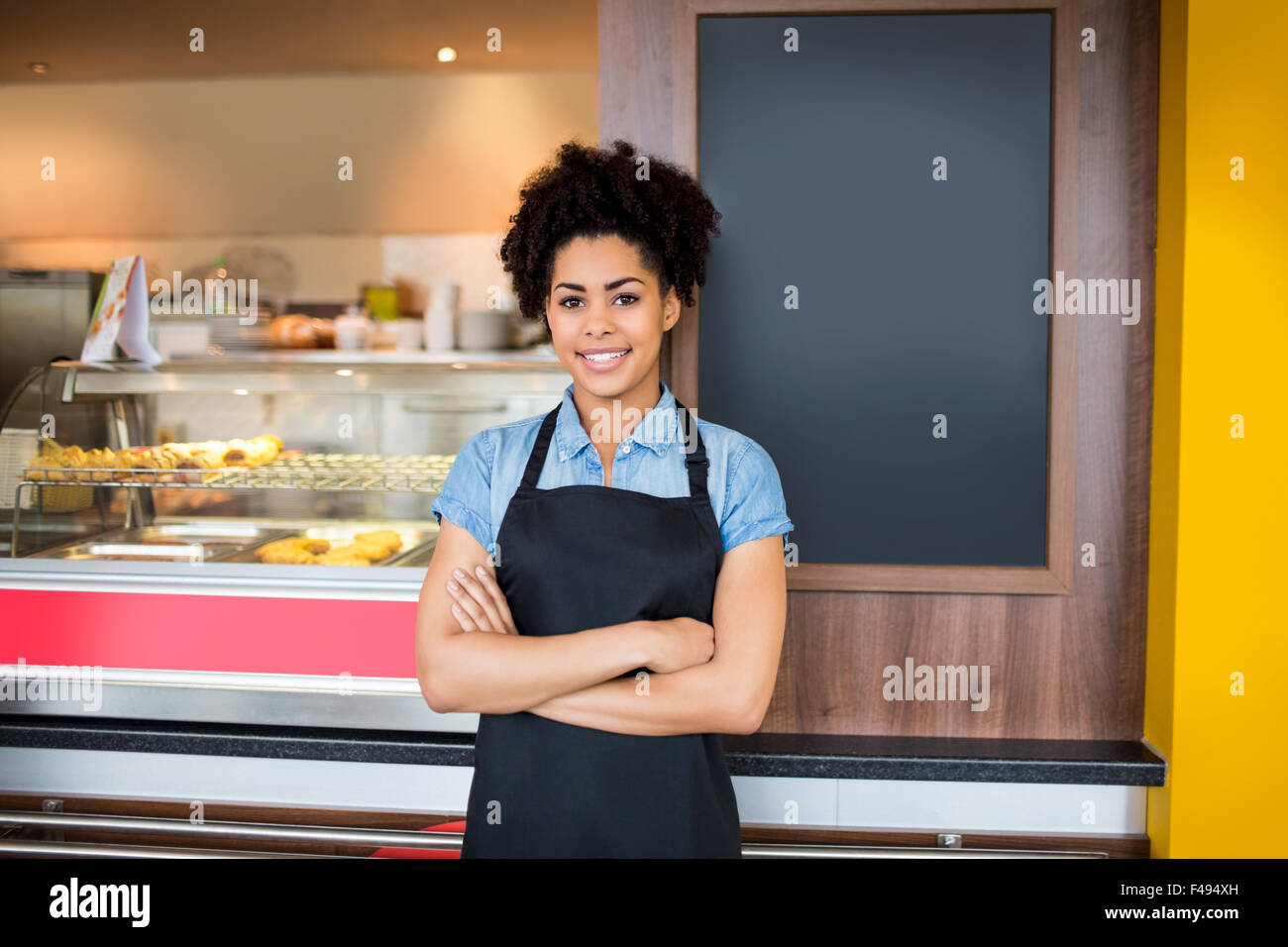 Pretty waitress smiling at camera Stock Photo - Alamy