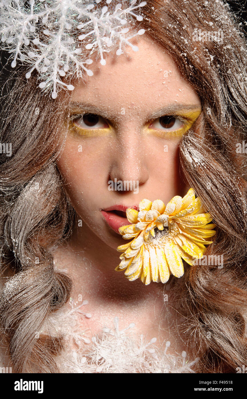 girl with flower in his teeth on snow Stock Photo - Alamy