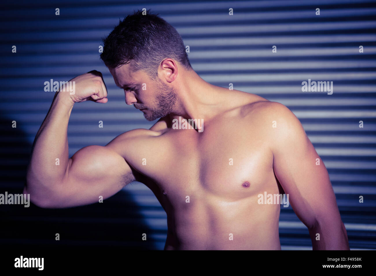 Muscular man posing Stock Photo - Alamy