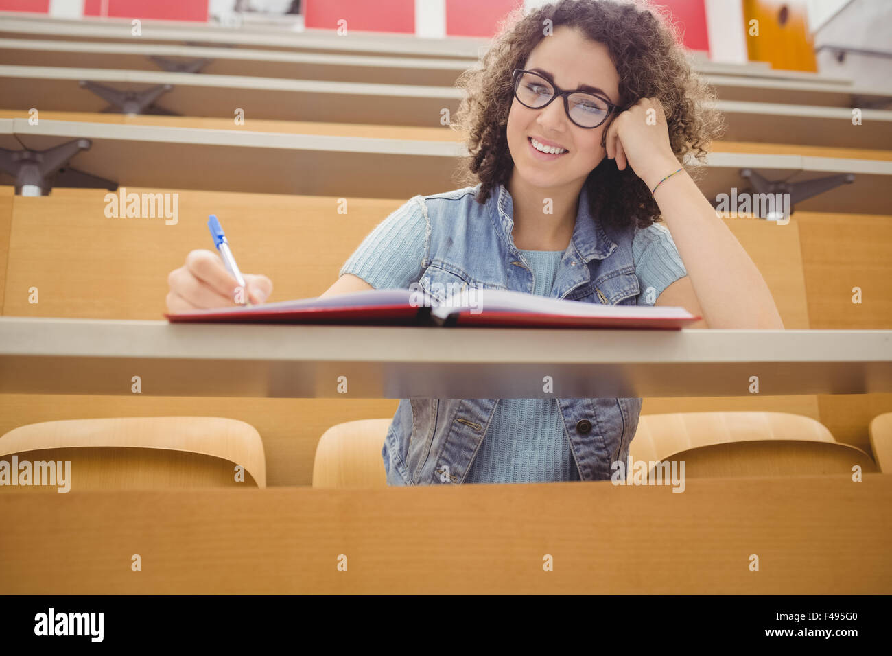 Student taking notes in lecture Stock Photo - Alamy