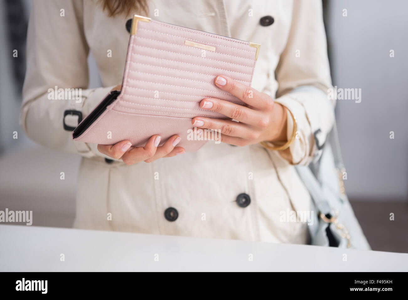 Woman opening her wallet Stock Photo - Alamy