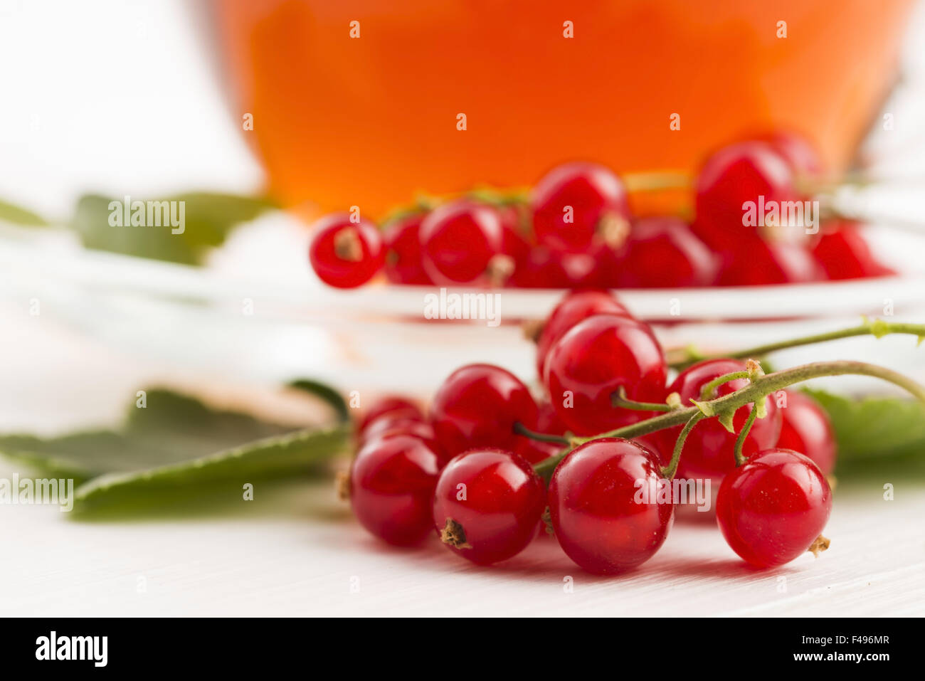 tea in cup and fresh red currant Stock Photo - Alamy