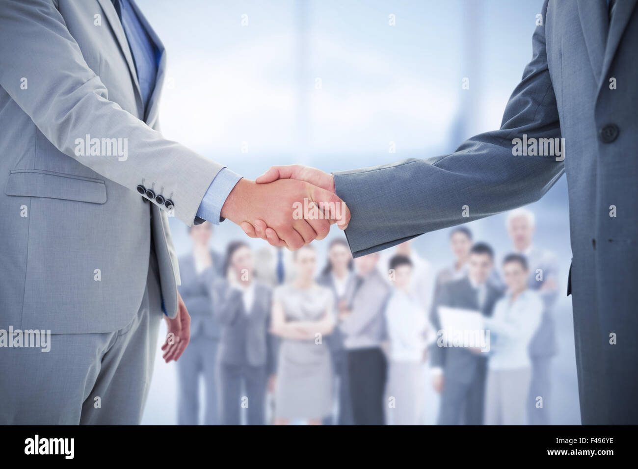 Composite image of business handshake Stock Photo - Alamy
