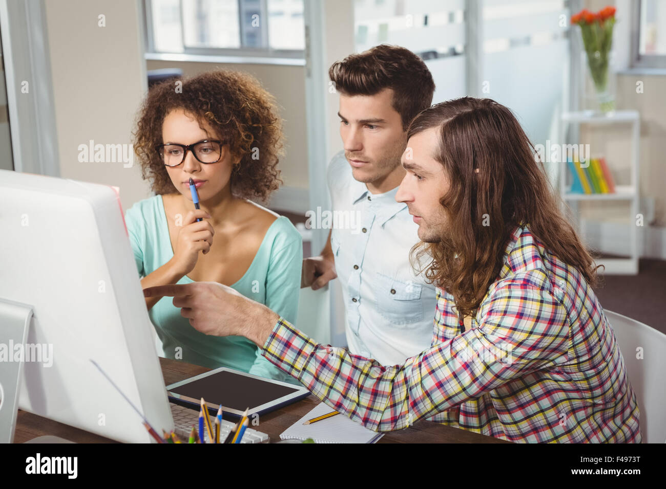 Businessman explaining on computer screen Stock Photo - Alamy