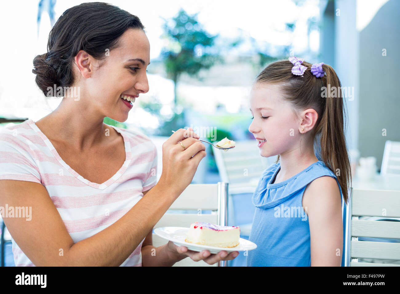 Mother feeding her daughter with cake Stock Photo - Alamy
