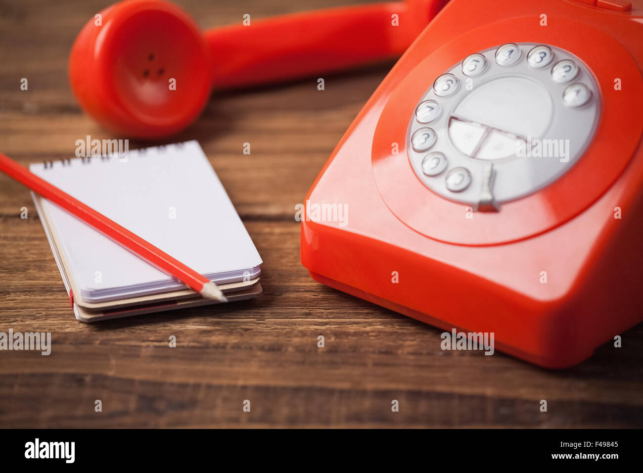 Telephone on table with notepad Stock Photo - Alamy