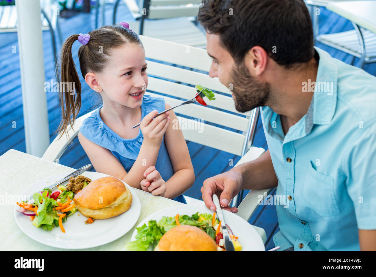Daughter and father eating at the restaurant Stock Photo - Alamy