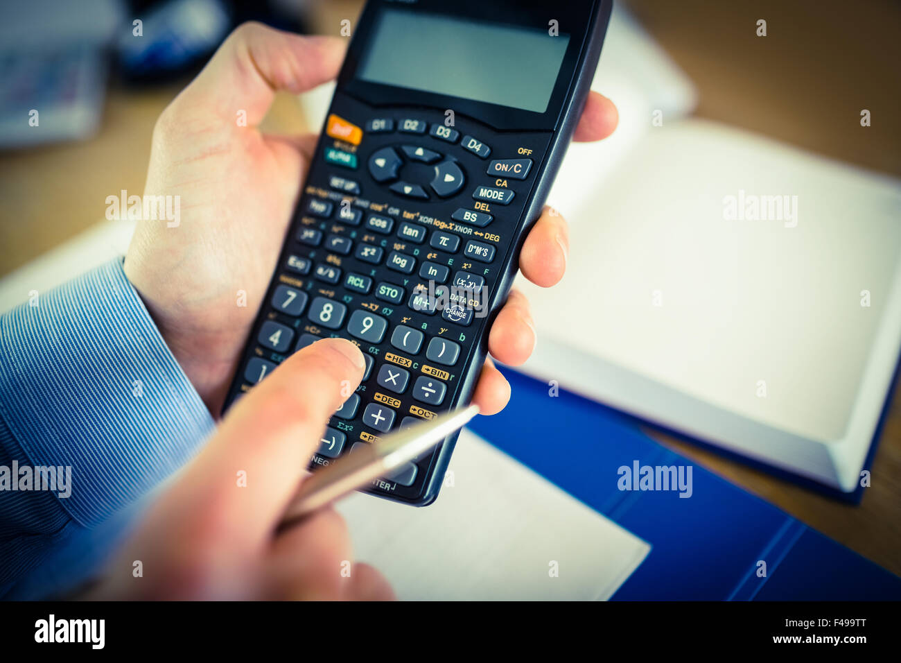 Businessman hands typing on calculator Stock Photo - Alamy
