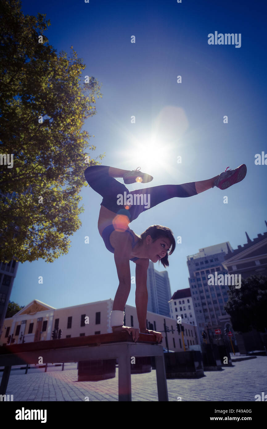 Athletic woman performing handstand on bench Stock Photo - Alamy
