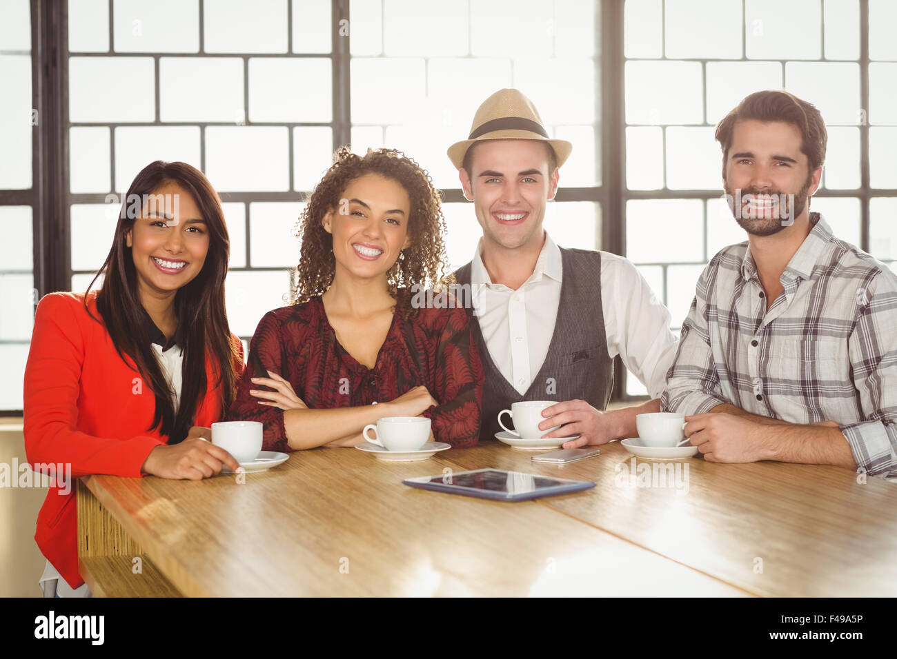 Smiling friends looking at the camera Stock Photo - Alamy