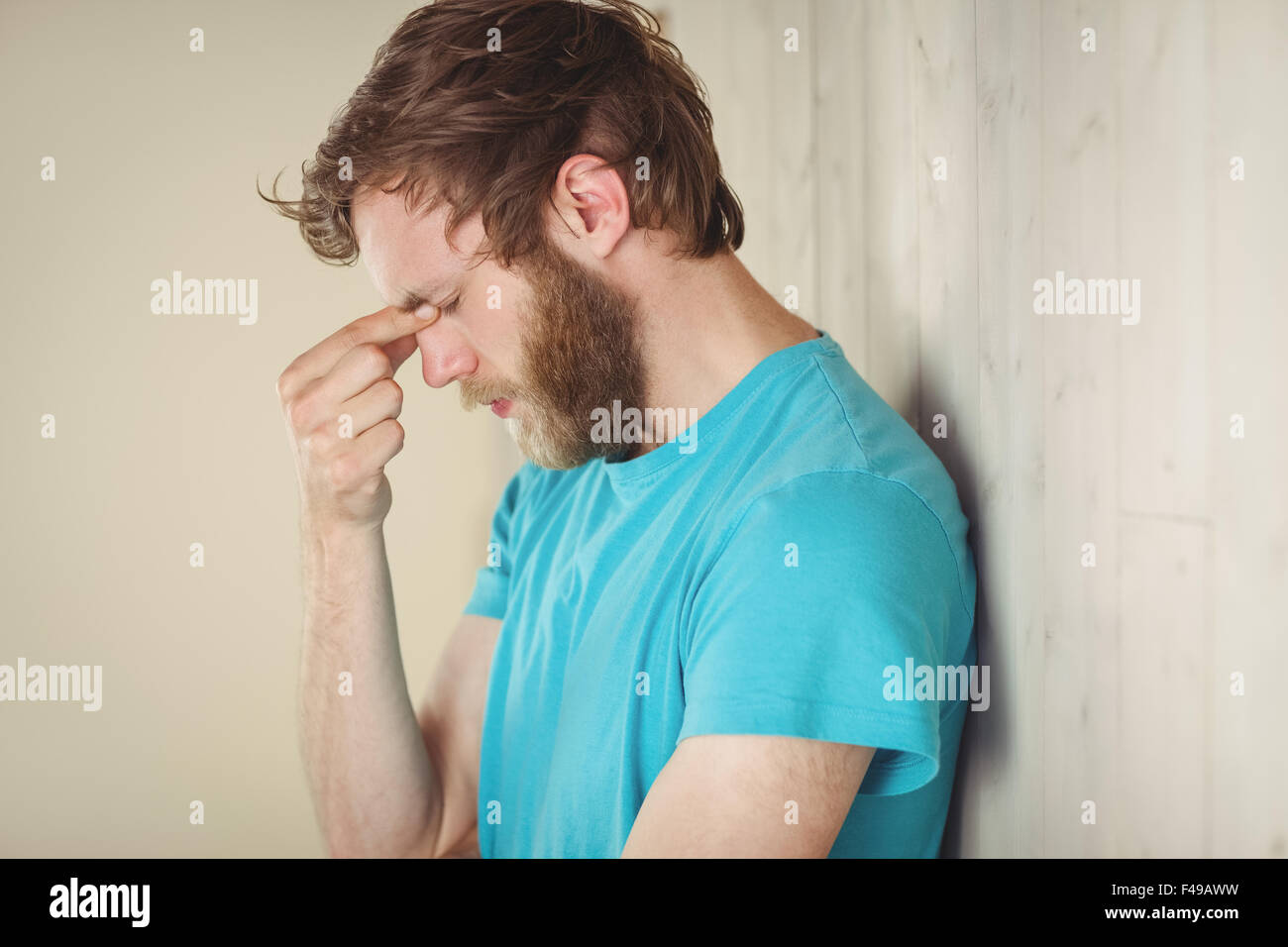 Upset man leaning his head against a wall Stock Photo - Alamy