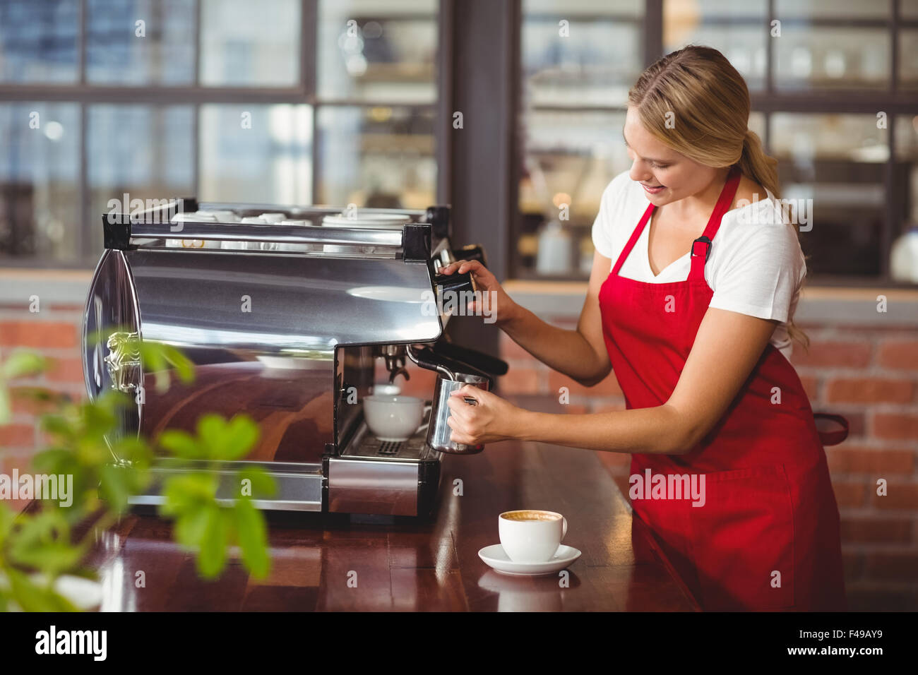 A pretty barista preparing coffee Stock Photo - Alamy