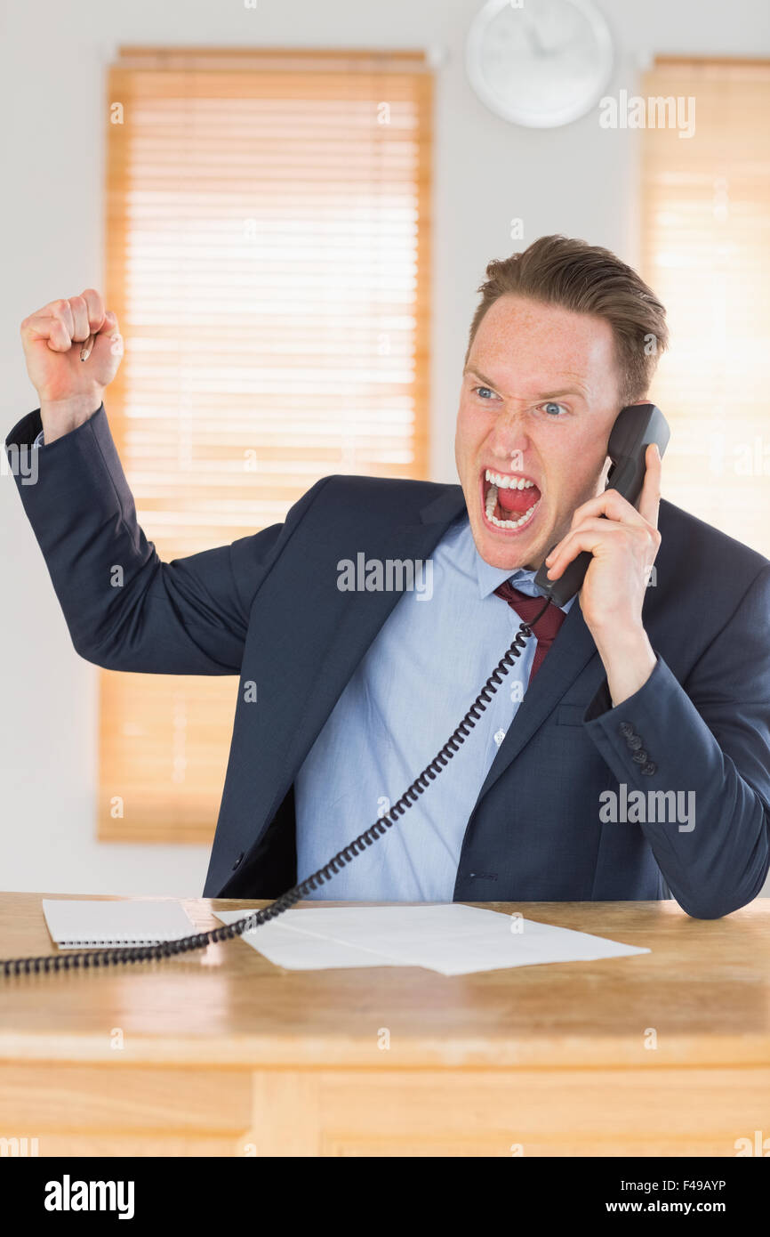 Furious businessman outraged on the phone Stock Photo - Alamy