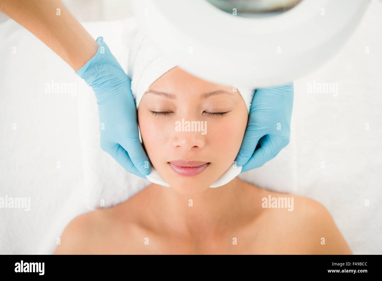Hands cleaning woman face with cotton swabs Stock Photo - Alamy