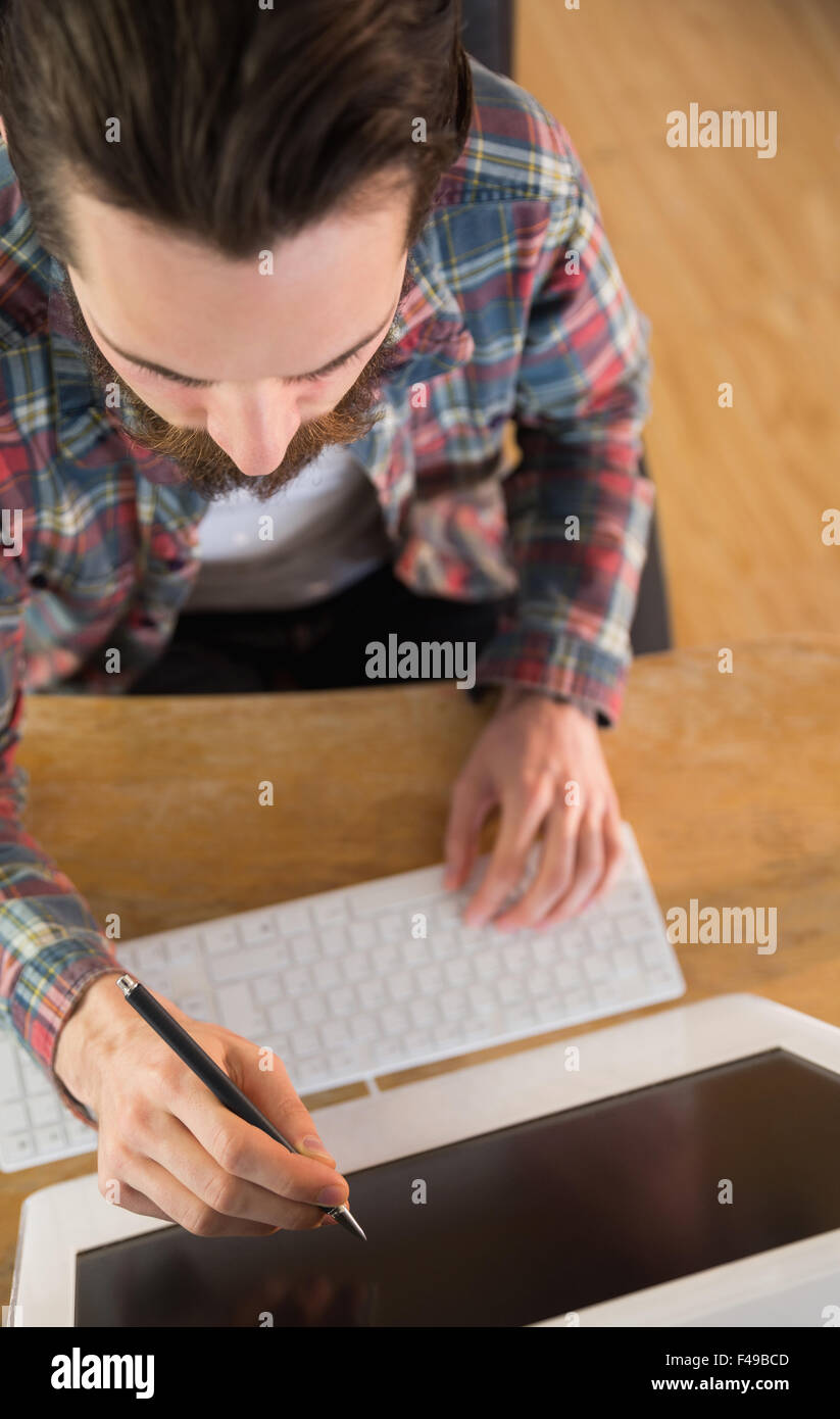 Businessman pointing at computer with pen Stock Photo - Alamy
