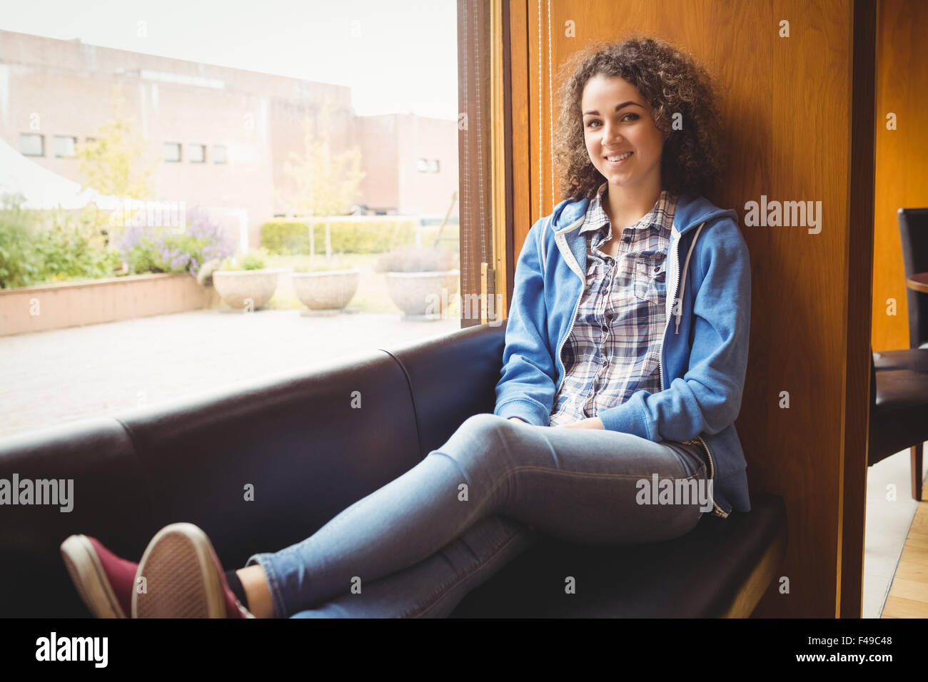 Pretty student sitting by the window Stock Photo - Alamy