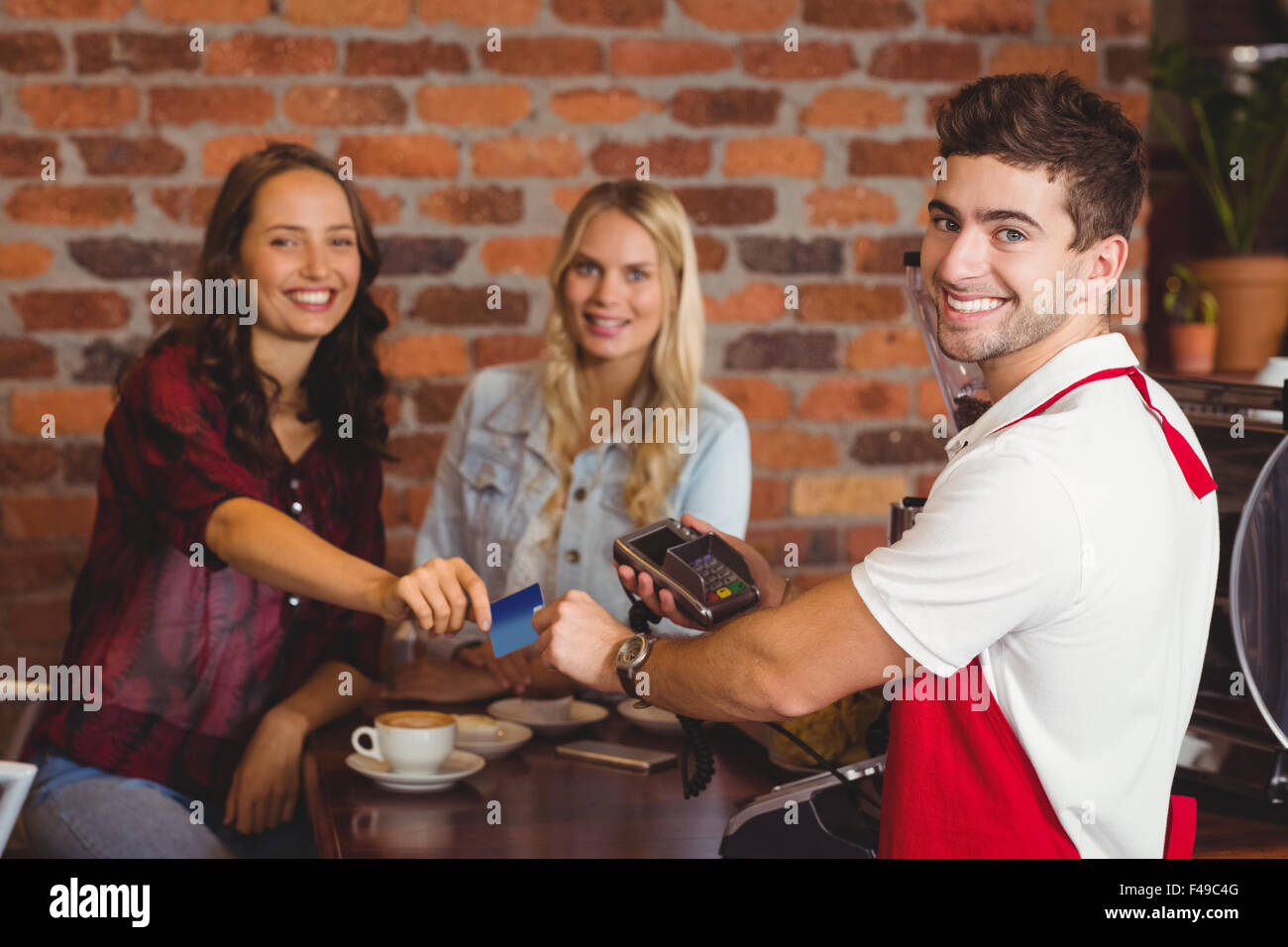 Pretty friends handing a credit card Stock Photo - Alamy