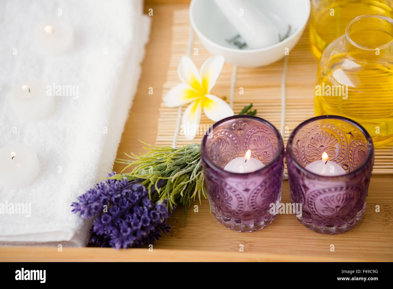 Massage tray with candles and oil Stock Photo - Alamy