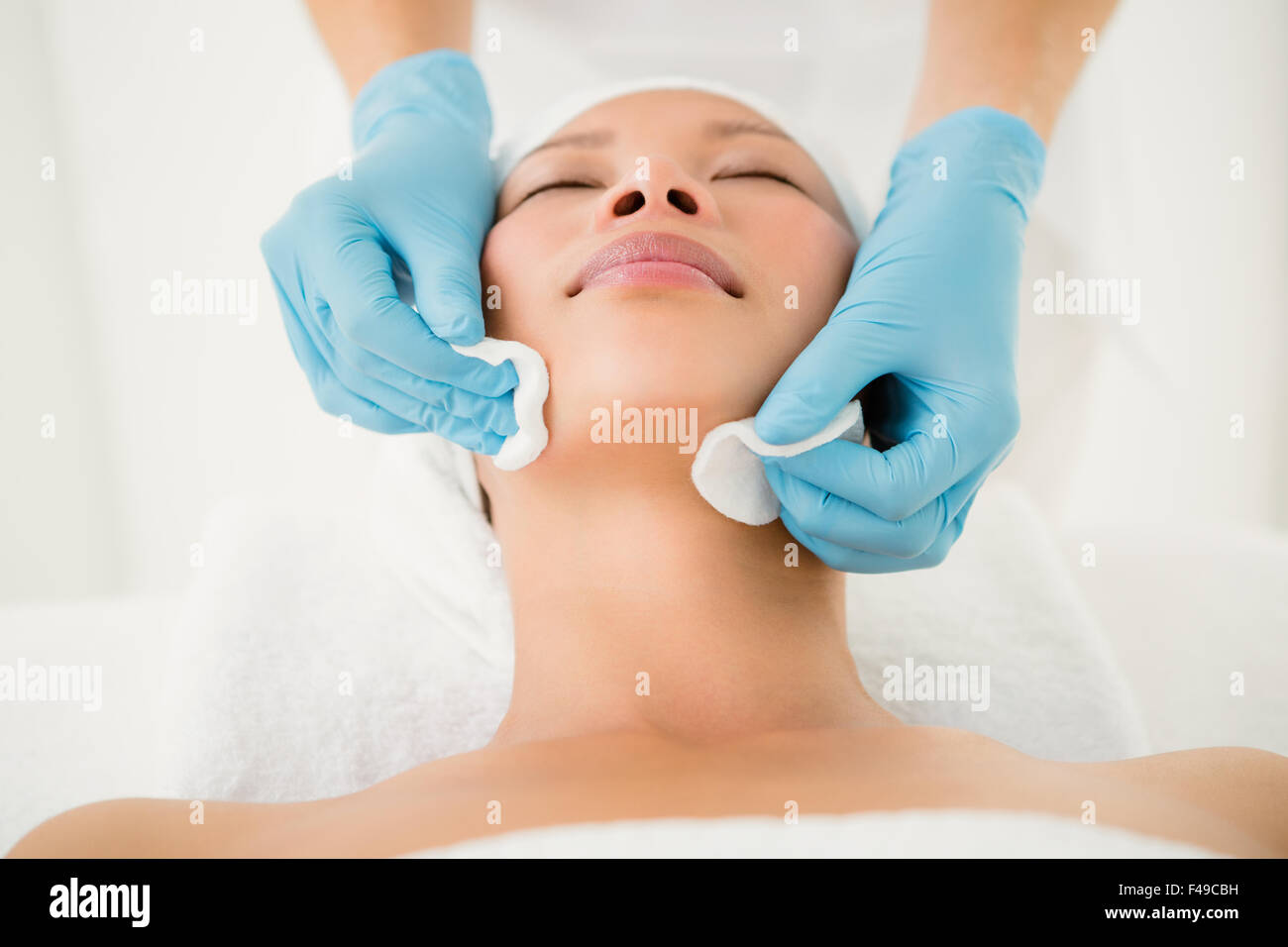 Hands cleaning woman face with cotton swabs Stock Photo - Alamy