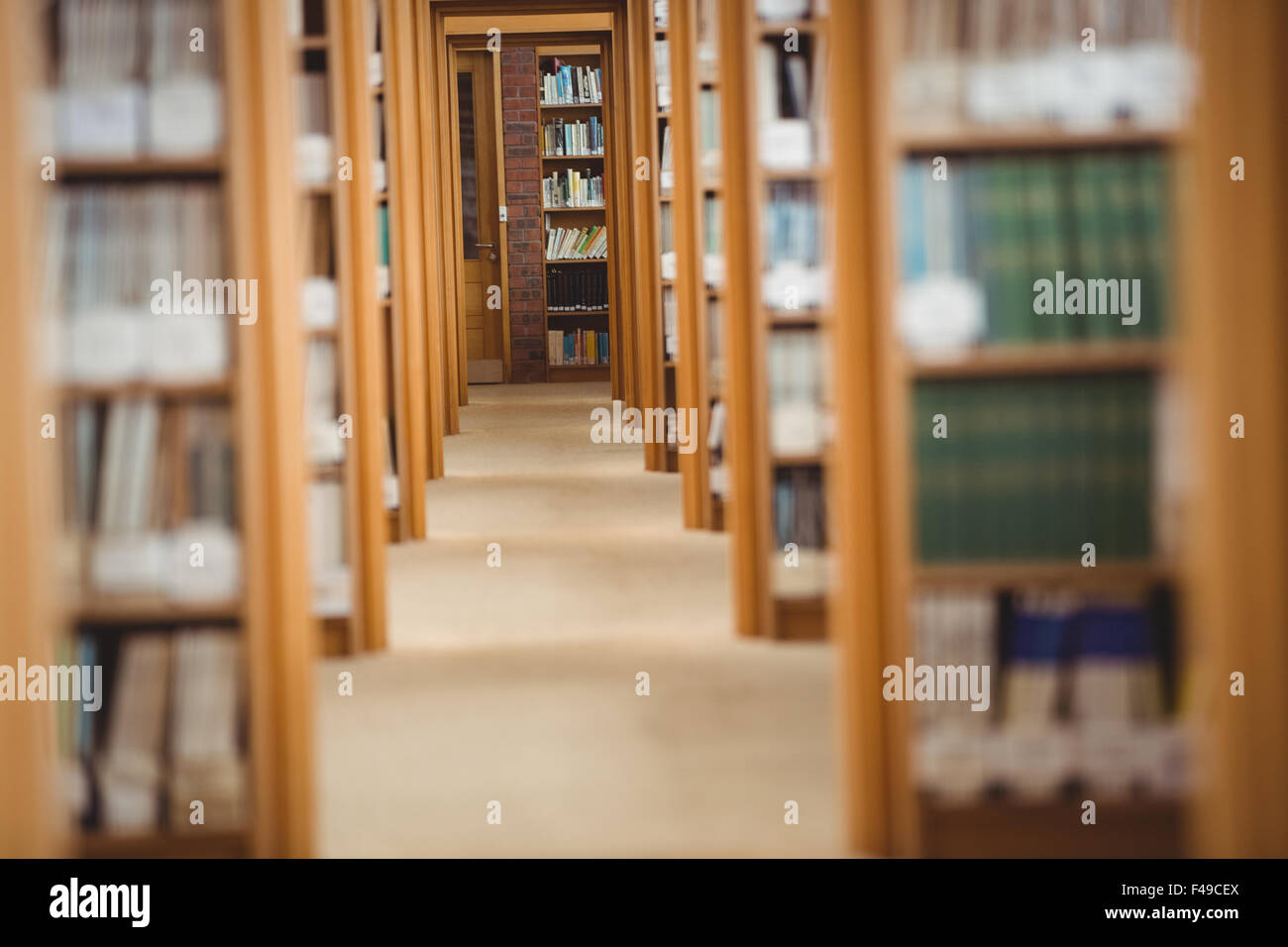 Empty aisle in library Stock Photo - Alamy