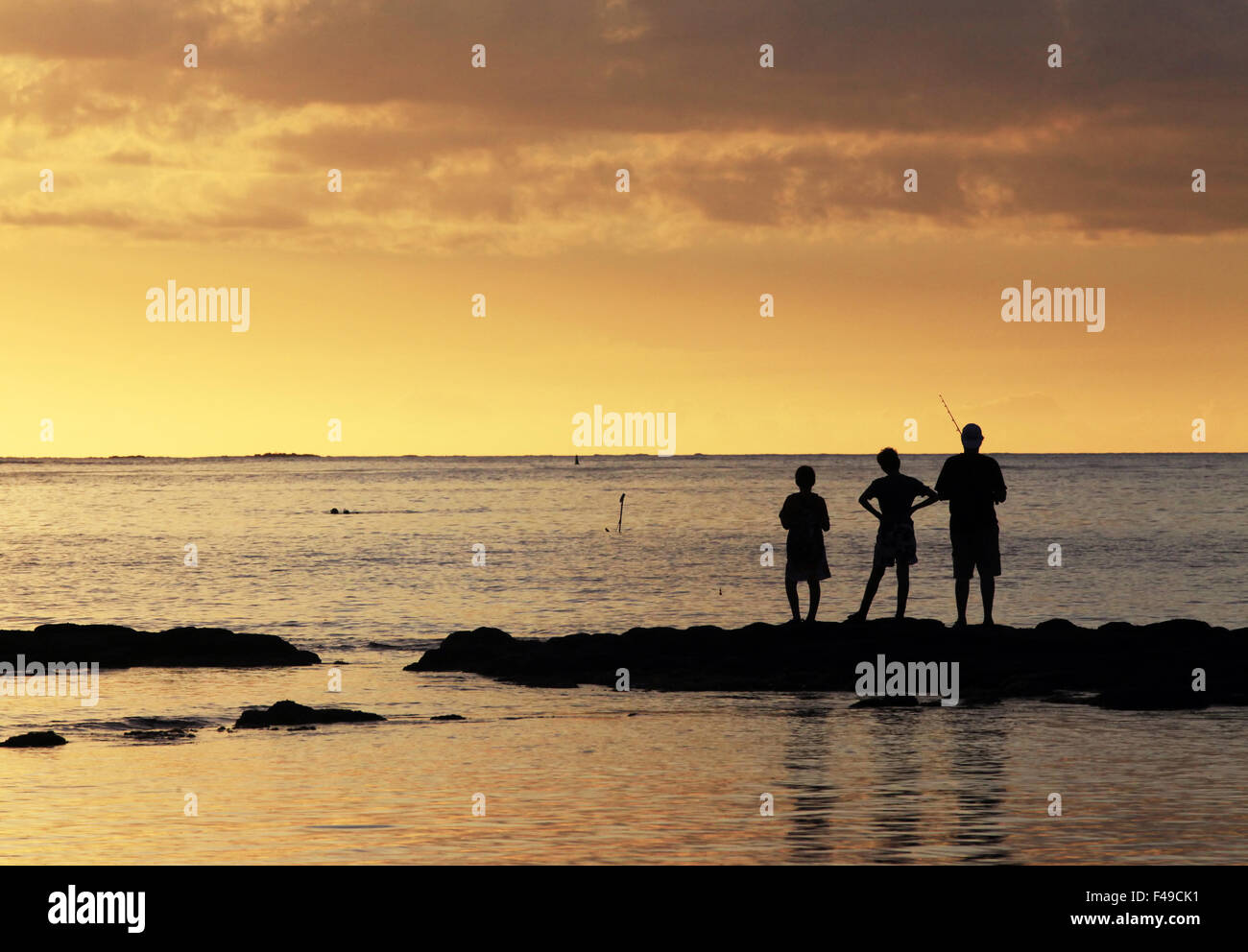 Three young fishermen Stock Photo - Alamy