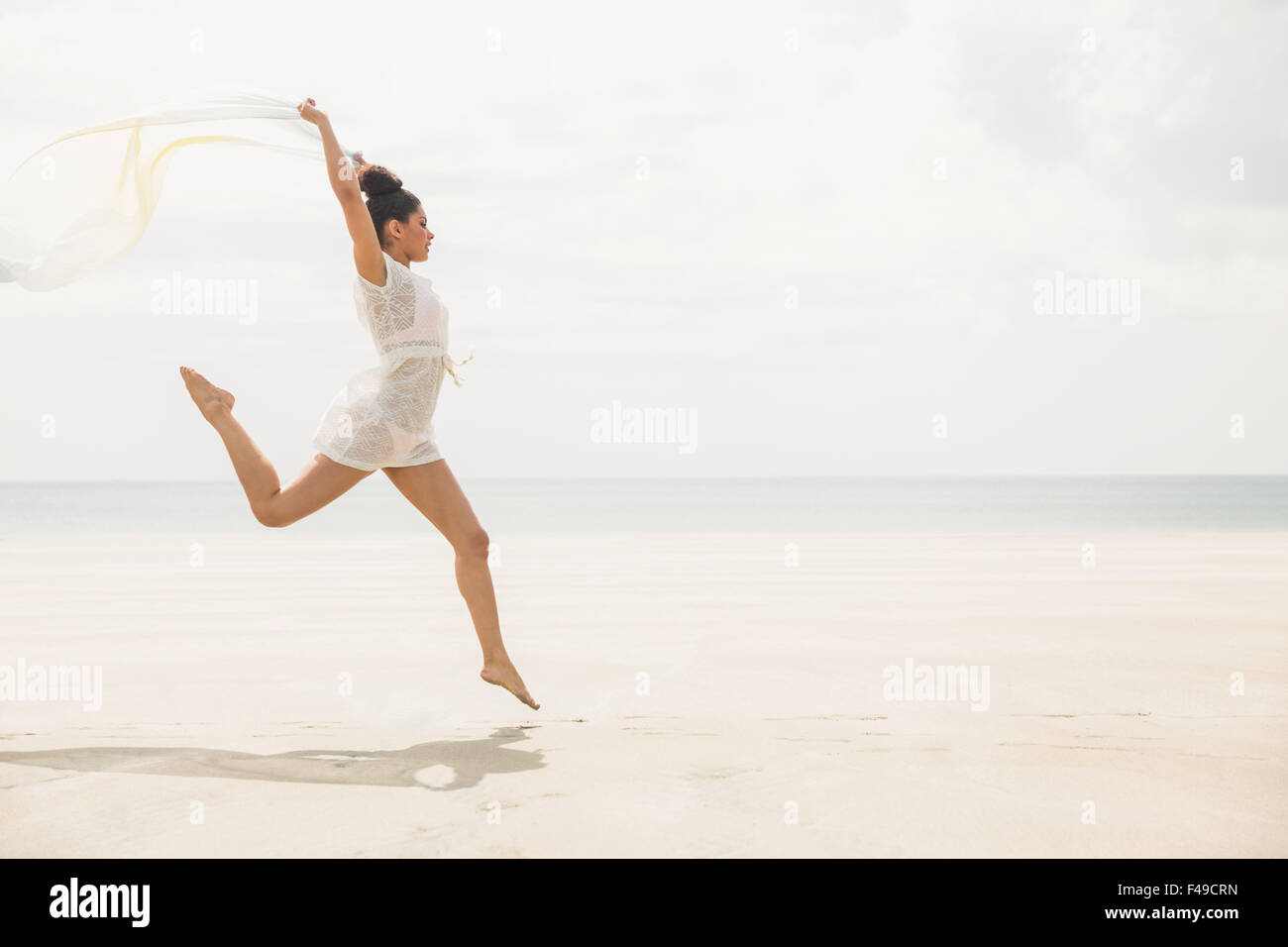 Woman leaping beach hi-res stock photography and images - Alamy