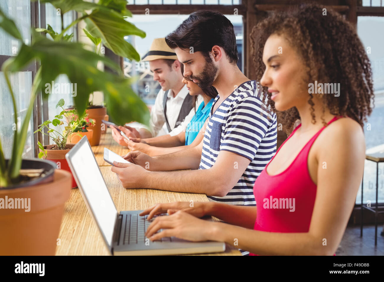 Happy friends using electronic devices Stock Photo - Alamy
