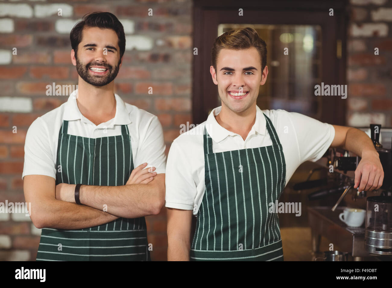 Two smiling baristas looking at the camera Stock Photo - Alamy