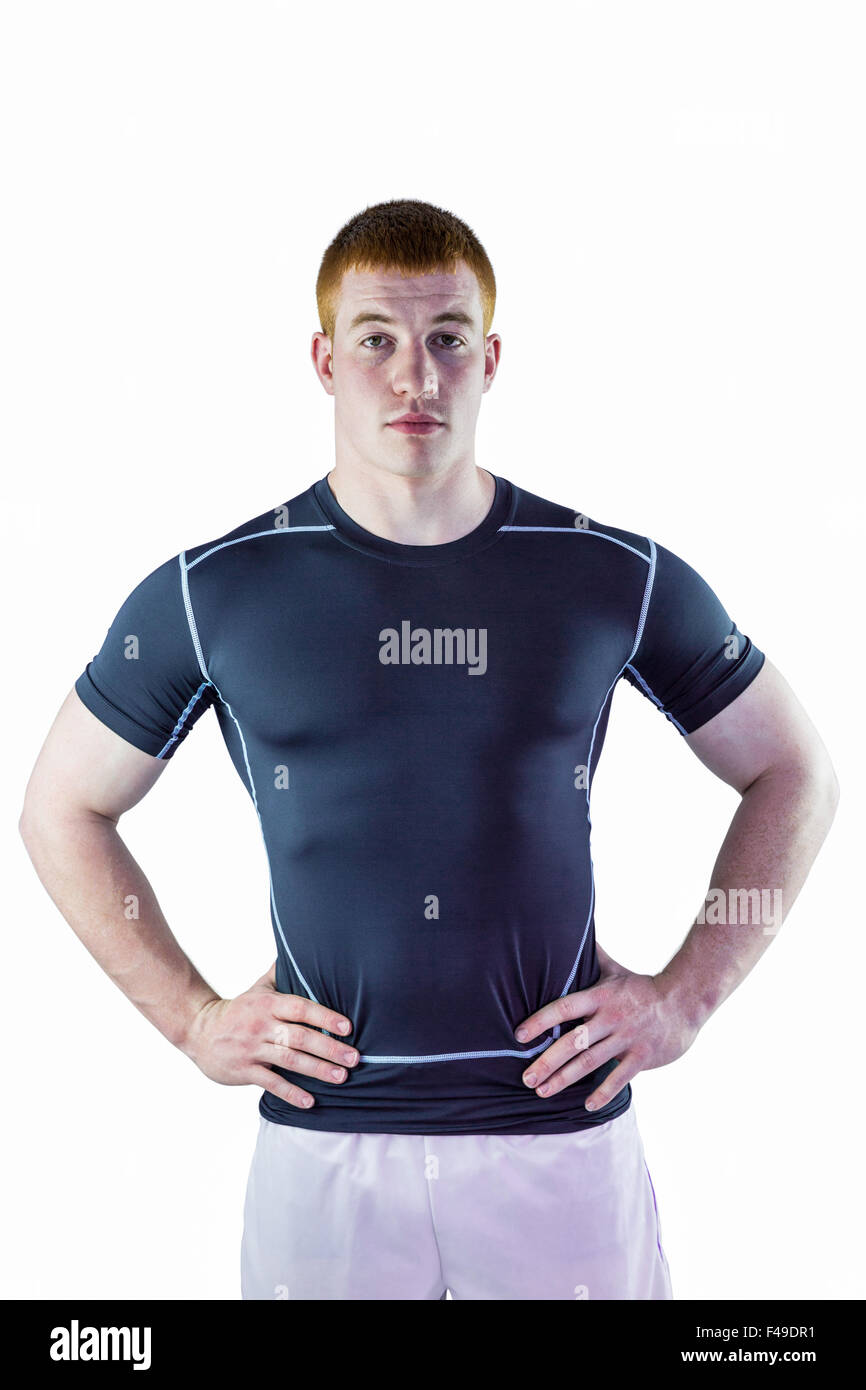 Muscular rugby player with hands on hips Stock Photo - Alamy
