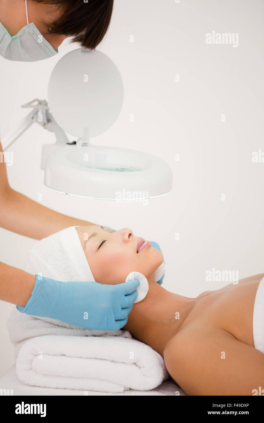 Hands cleaning woman face with cotton swabs Stock Photo - Alamy