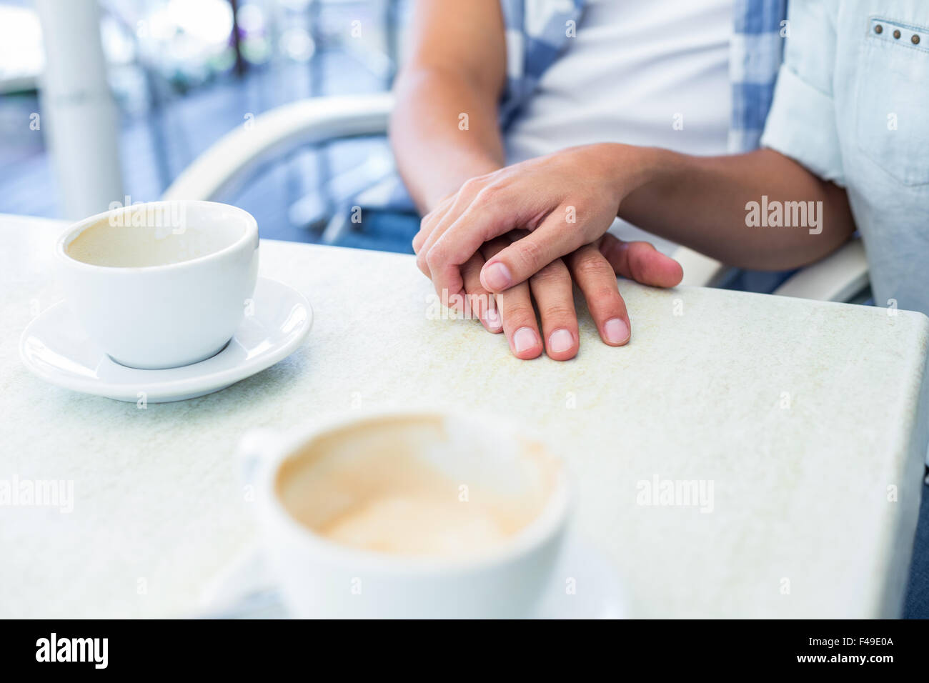 Cute couple on a date holding hands Stock Photo - Alamy