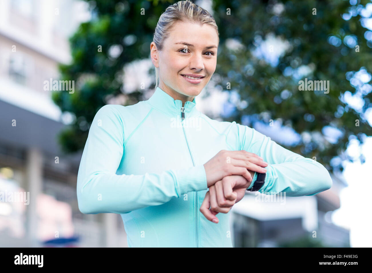 A beautiful athlete watching her watch Stock Photo - Alamy