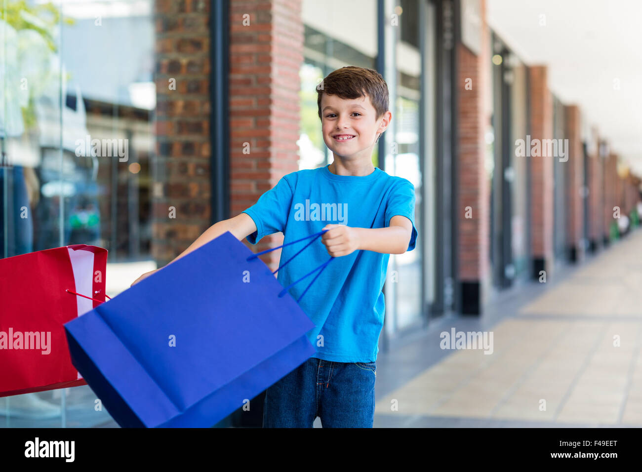 Young boy playing with shopping bags Stock Photo - Alamy