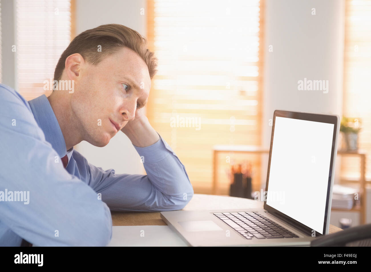 Focused businessman looking at laptop Stock Photo - Alamy