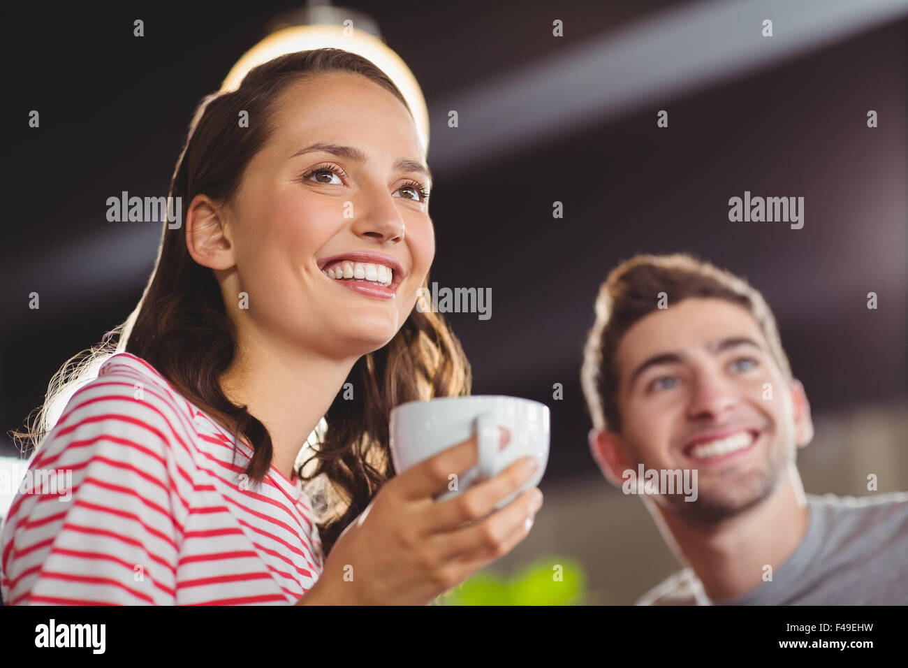 Smiling friends enjoying coffee together Stock Photo - Alamy