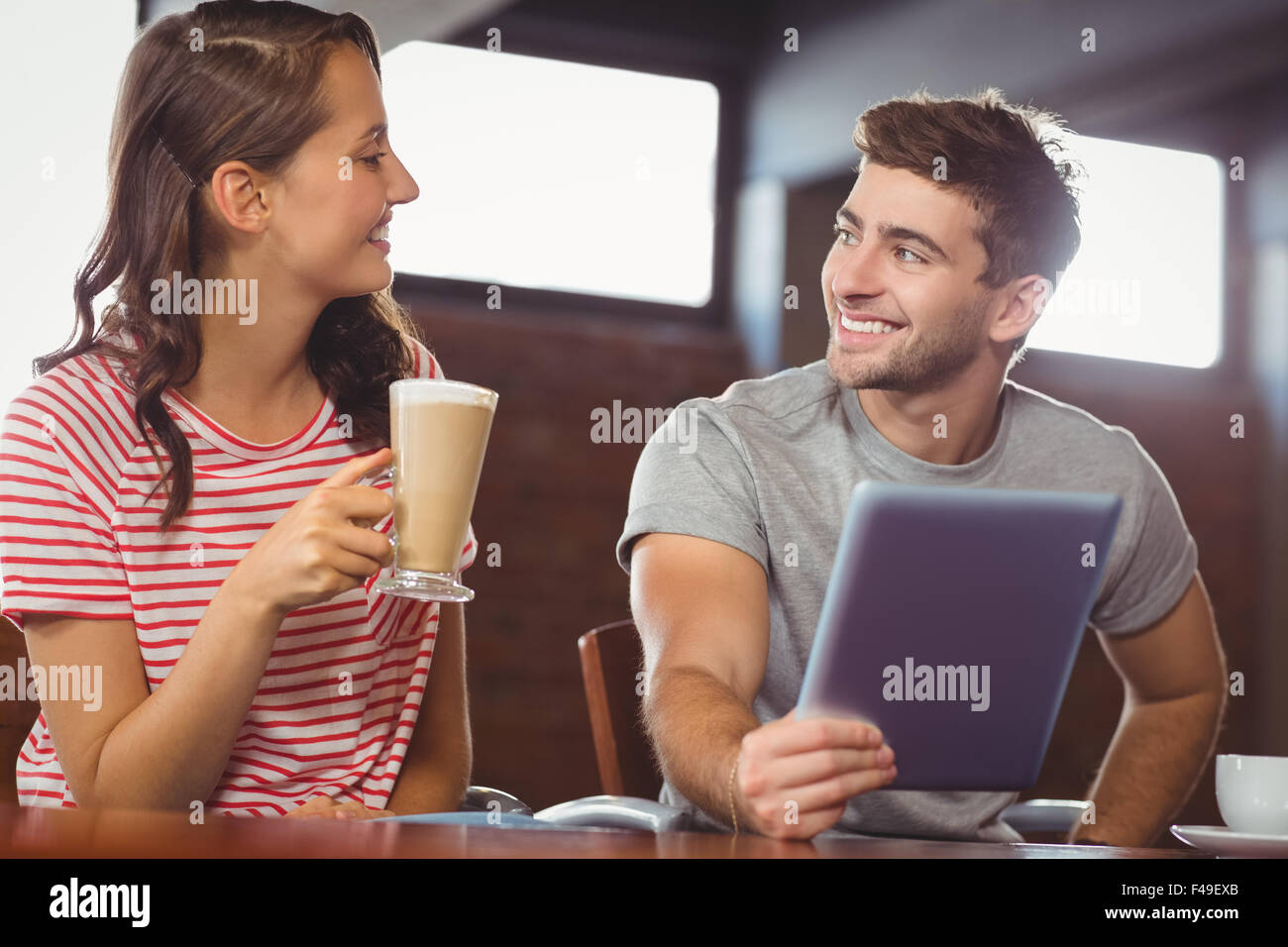 Smiling friends looking at each other Stock Photo - Alamy