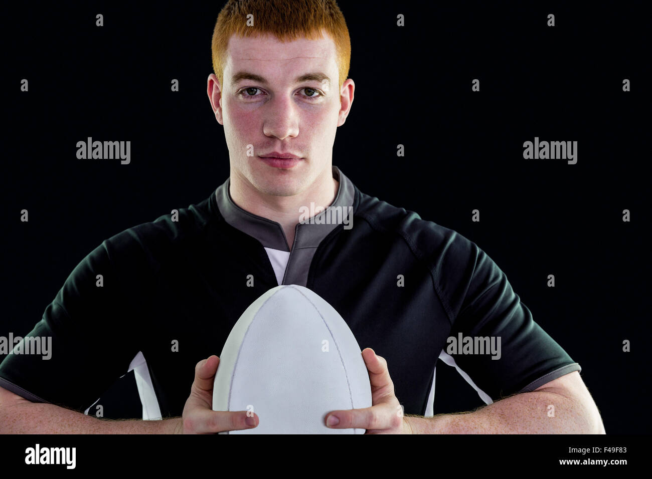 Smiling rugby player holding a rugby ball Stock Photo - Alamy
