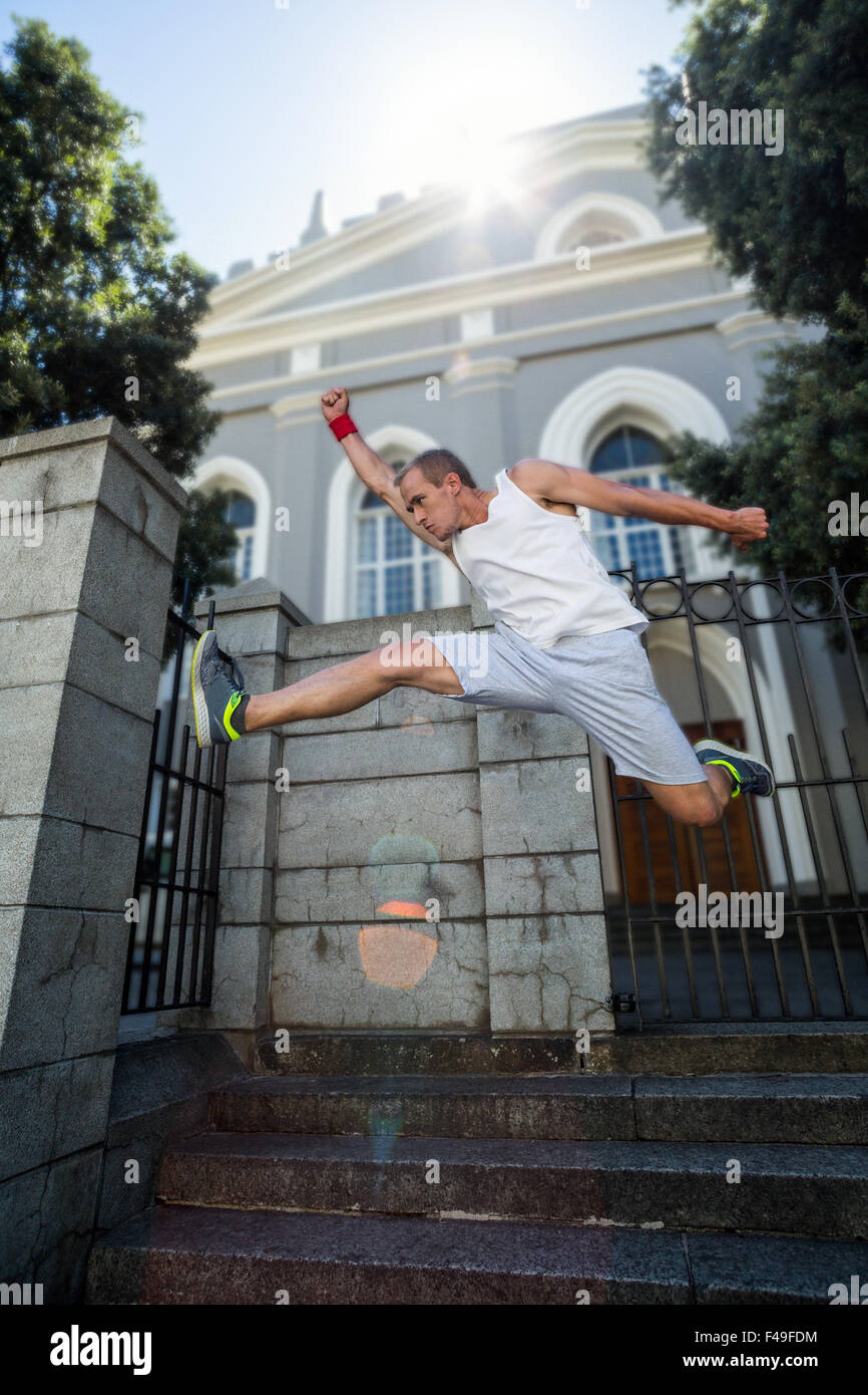 Extreme athlete jumping in front of building Stock Photo - Alamy