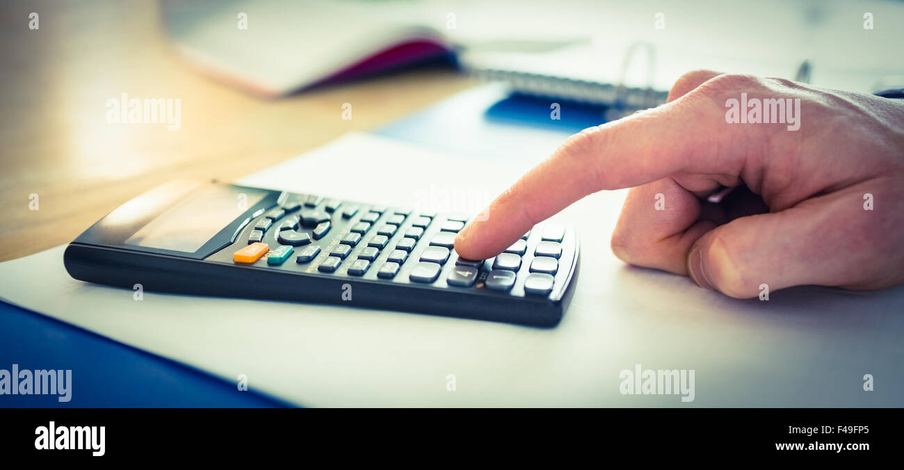 Businessman hands typing on calculator Stock Photo - Alamy