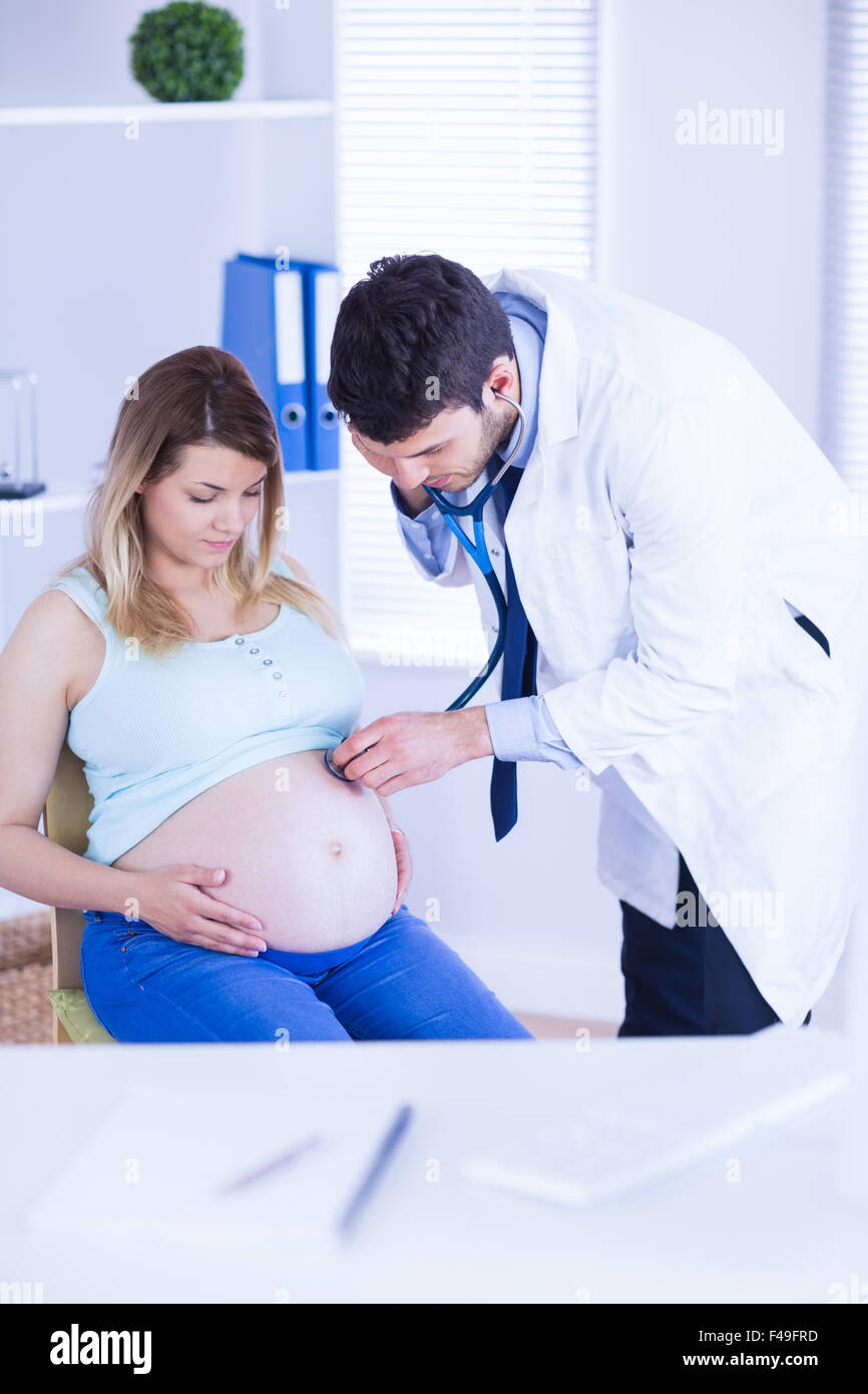 Doctor examining stomach female patient hi-res stock photography and ...