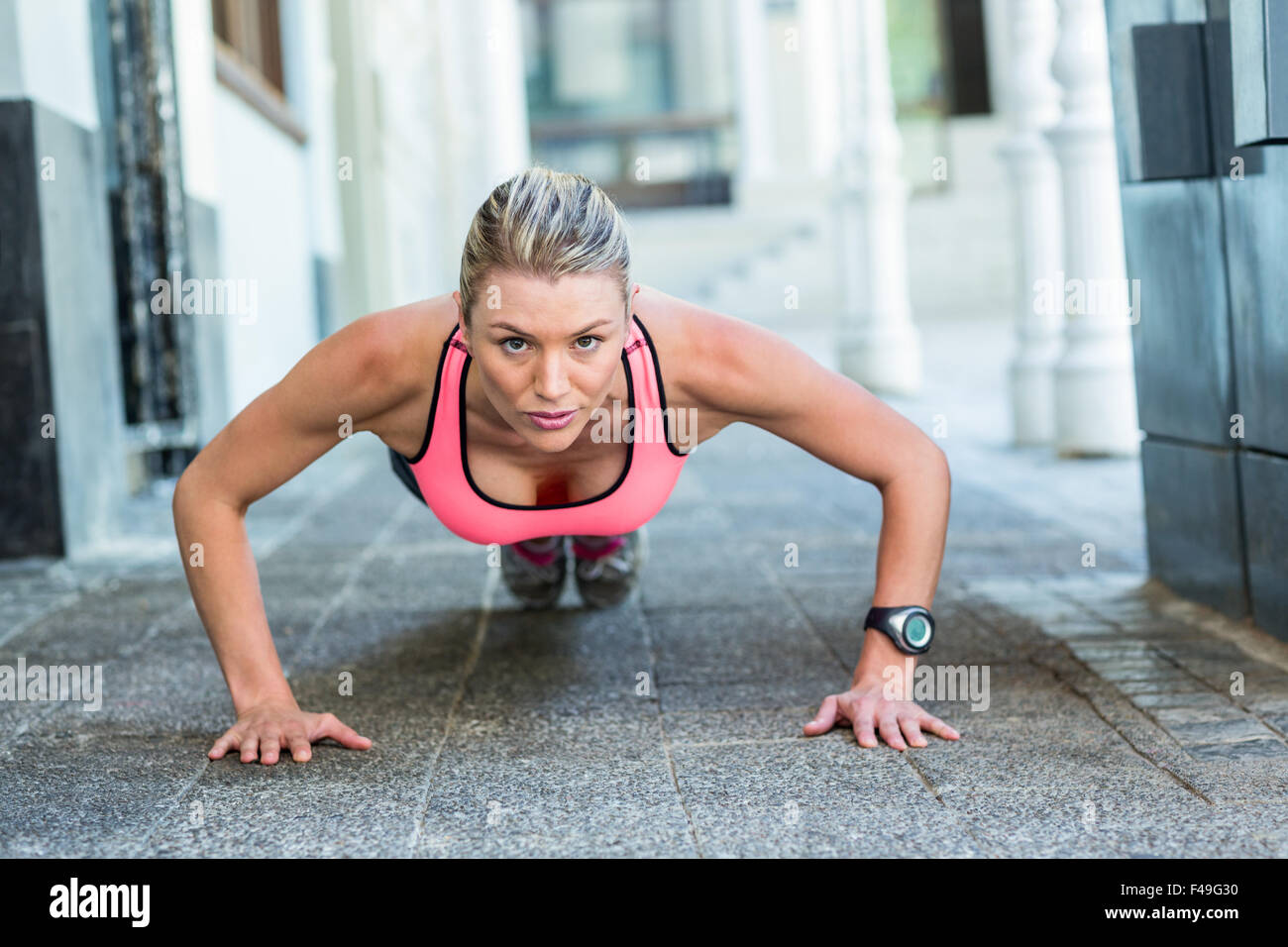 A pretty woman doing push-ups on the floor Stock Photo - Alamy