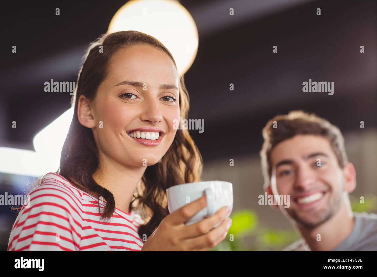 Smiling friends enjoying coffee together Stock Photo - Alamy