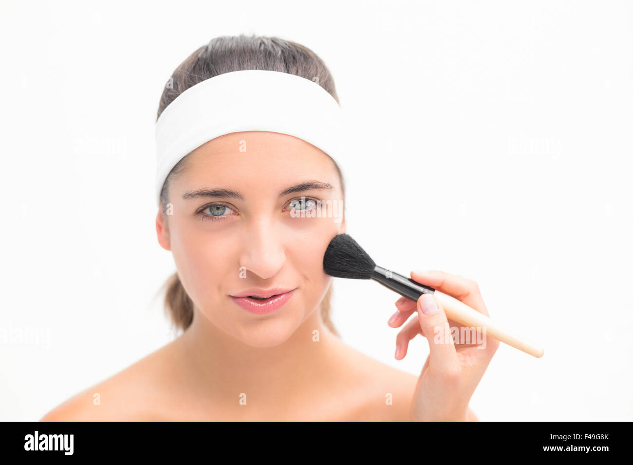 Hand applying blush to beautiful woman Stock Photo - Alamy